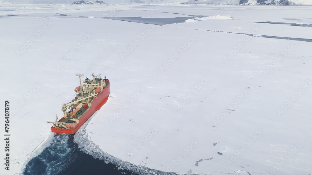 Icebreaker breaks through pack ice on its way. Red Nuclear icebreaker ...