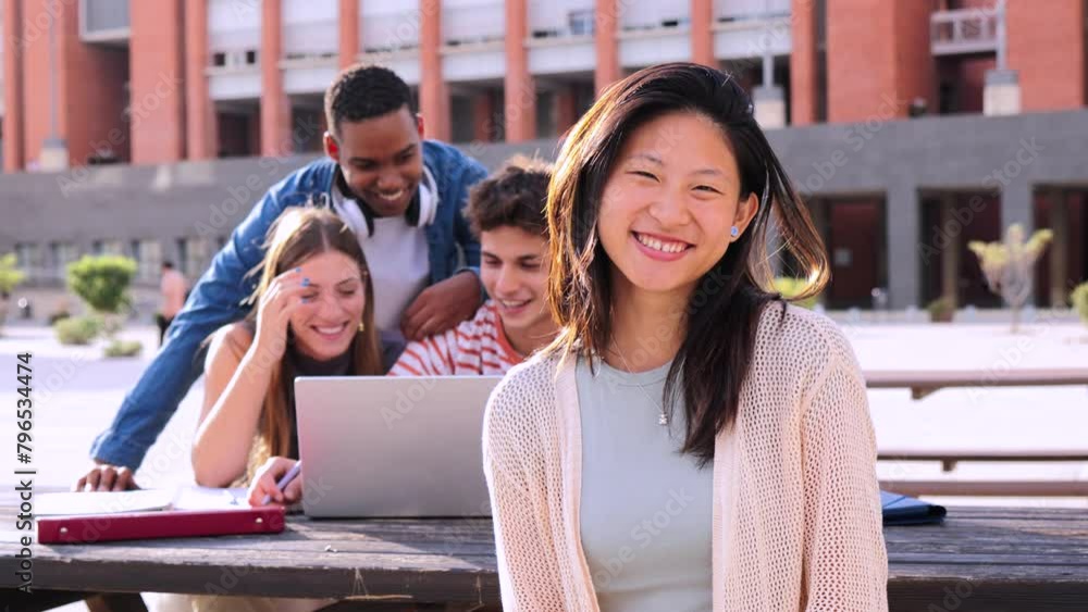 On foreground an asian schoolgirl staring front behind her multiracial ...