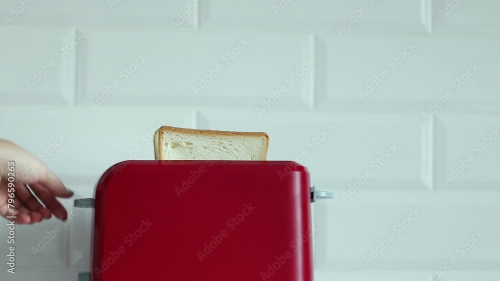 Woman hand putting two pieces in red bright toaster, Roasted toast ...