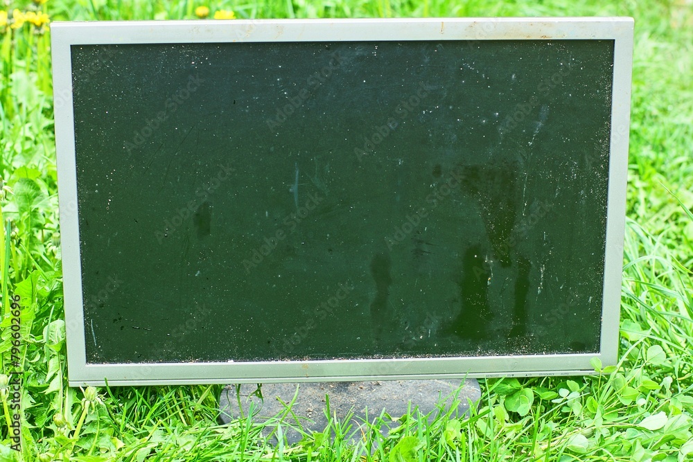 one old broken dirty discarded plastic black computer monitor with a ...