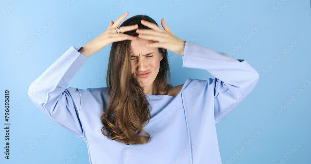 Frustrated nervous woman mad touch head against blue background ...