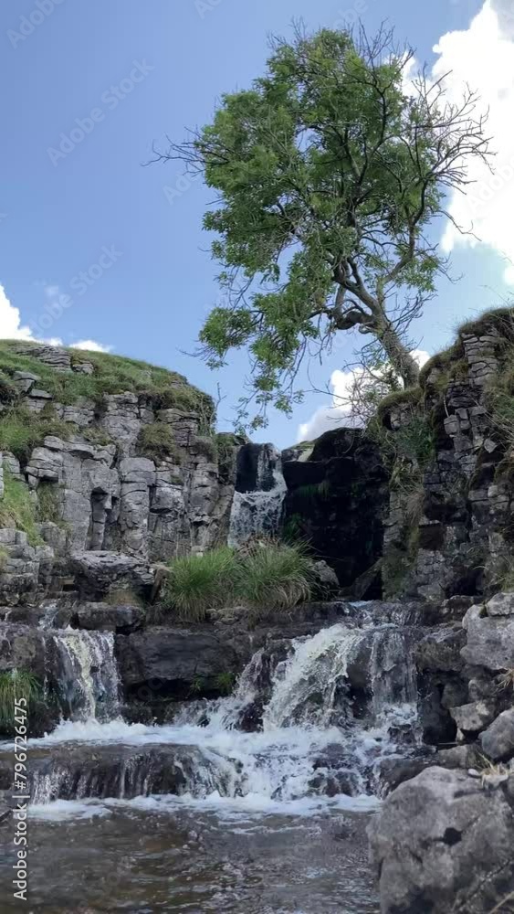 Beautiful waterfall gently cascades over limestone rocks with a single ...