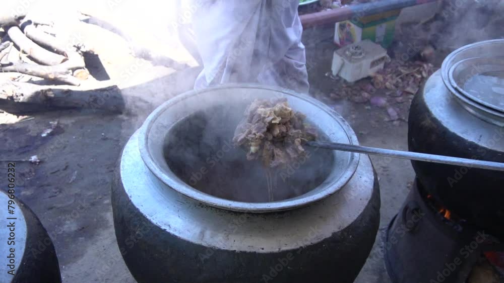 Man Cooking Beef Meat In Large Iron Cast Pots Using Firewood. Pakistani ...