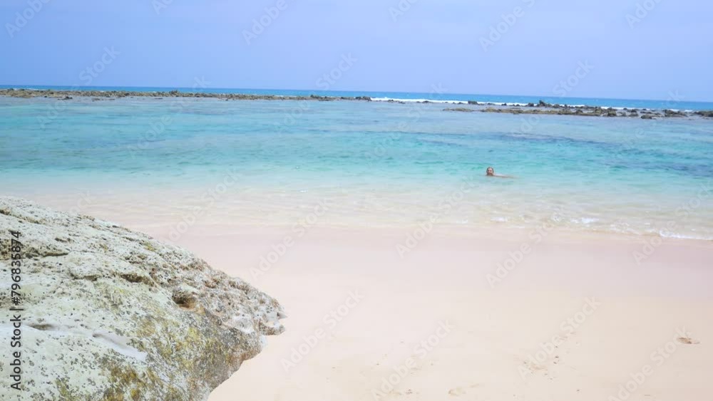 Middle aged woman floating swimming effortlessly in the pristine azure ...