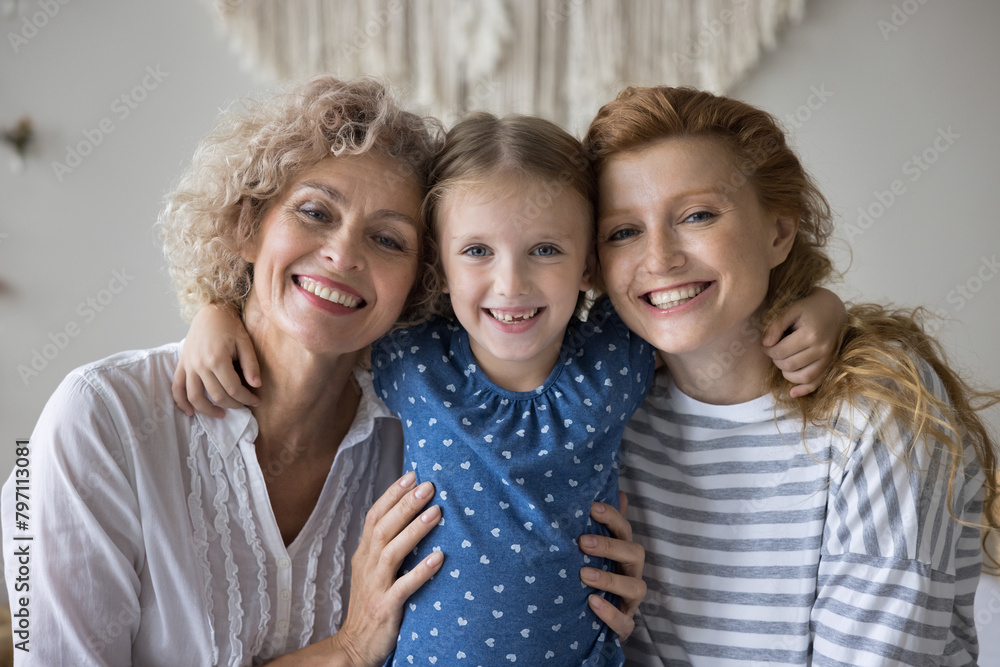 Portrait of multi-generational women, adorable preschooler 5s girl her ...