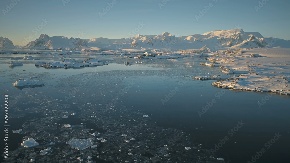 Antarctica aerial view drone flight, over ocean to the mountains. Fast ...