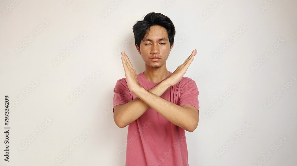 Young Asian man posing with crossed arms on an isolated white ...