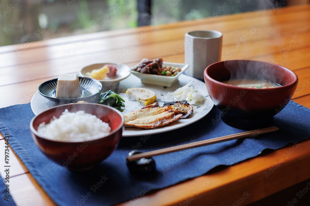 Japanese breakfast includes grilled fish, miso soup, tofu, rice ...