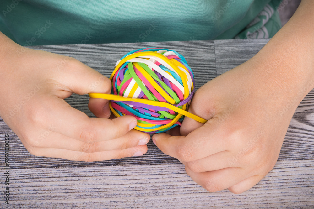 Preschooler hands playing with rubber bands or erasers. Development of ...