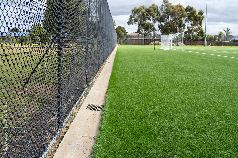 A soccer ground with artificial synthetic grass turf and water drainage ...