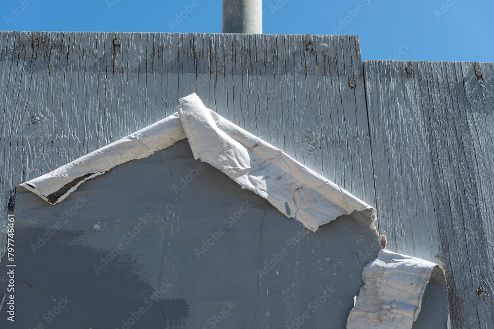 painted plywood hoarding with old peeling poster and blue sky Stock ...