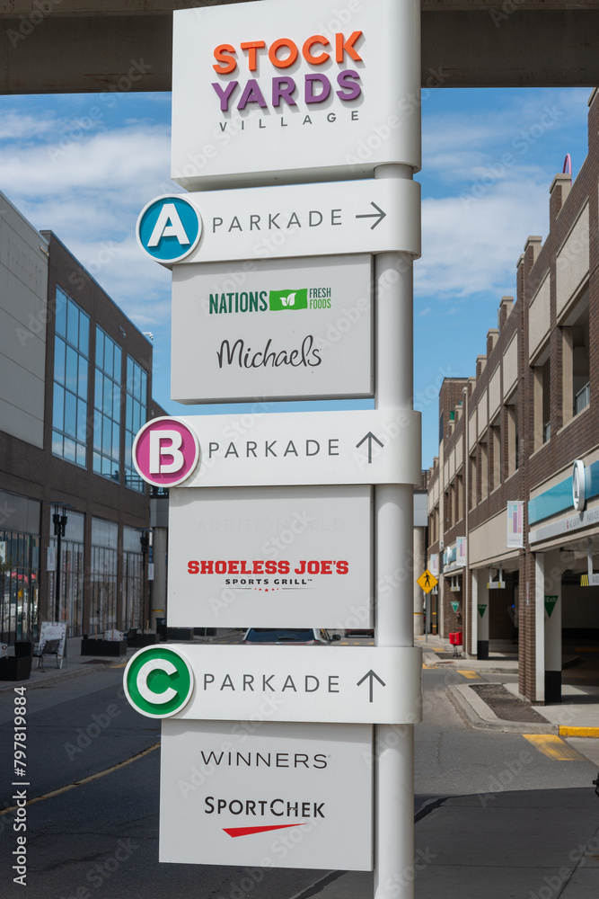parkade sign and shop directory at Stock Yards Village, a shopping mall ...