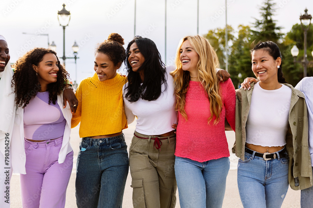 Young multicultural group of women walking together at city street ...