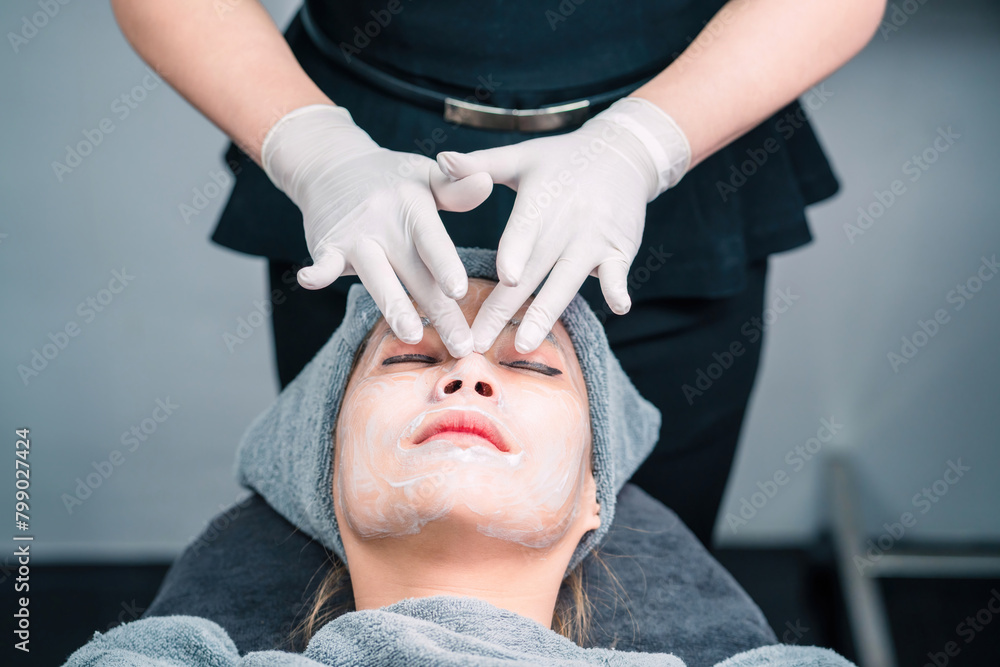 surgery person putting cream woman face for treatment. female asian ...