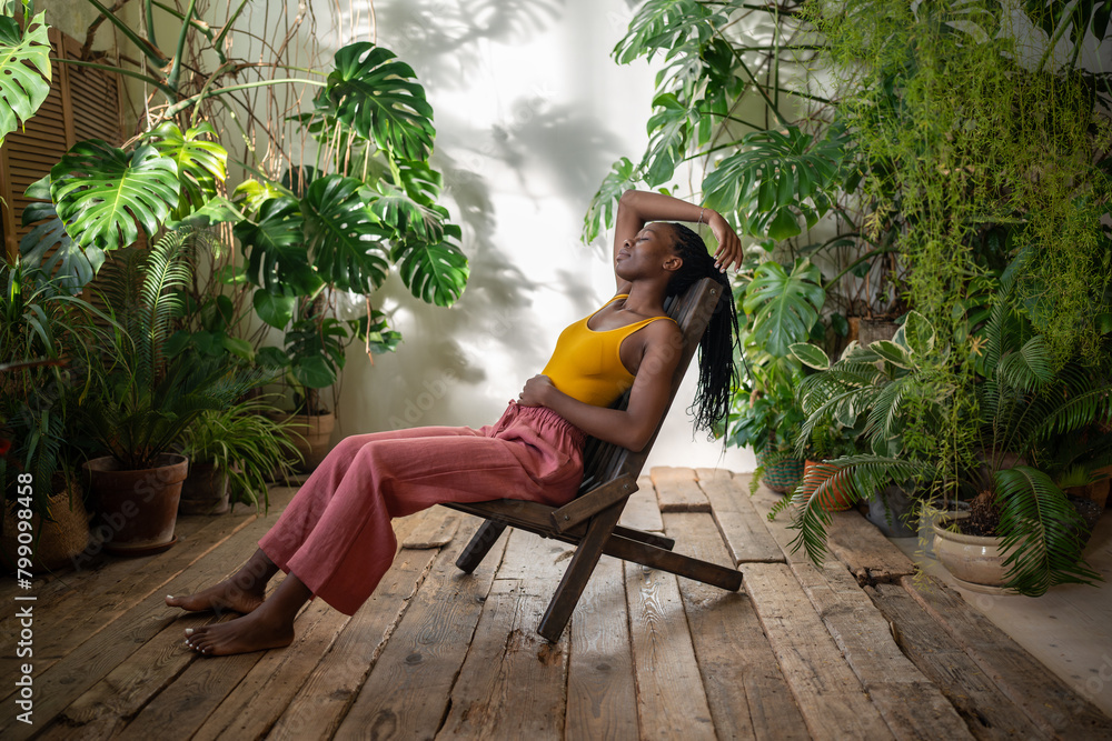 Carefree relaxed african american woman take break surround by tropical ...
