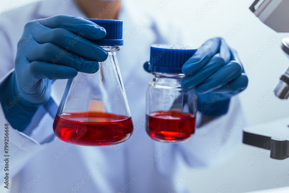 Hands of a doctor or female doctor collecting blood sample tubes from ...