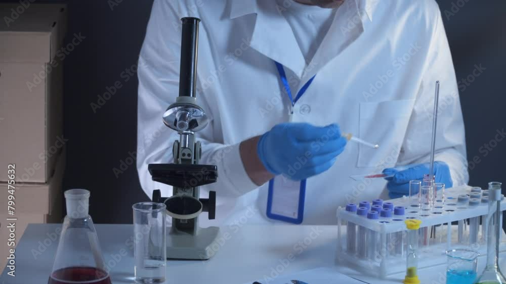 Health care worker with blood test tubes in clinical laboratory ...