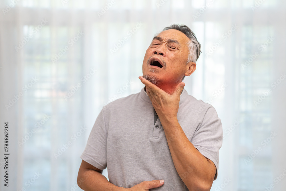Sick senior man touching neck unwell coughing with sore throat pain ...