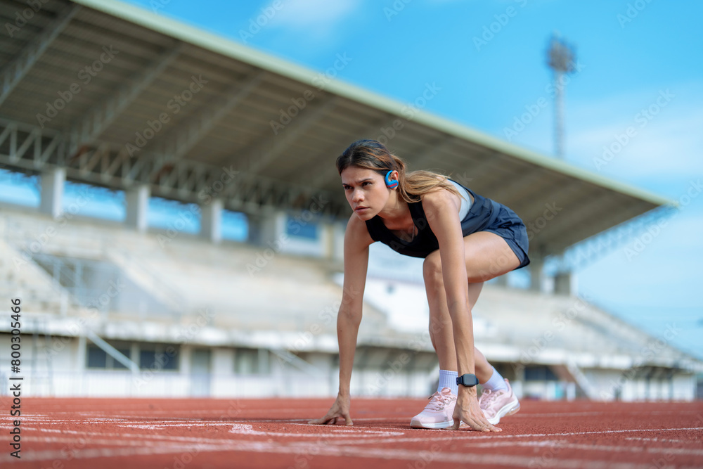 Beautiful Asian girl running at outdoor treadmill in sports stadium ...