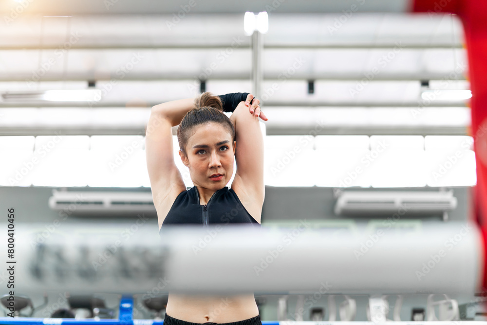 boxing woman stretching body wearing gloves on fighting ring. relax ...