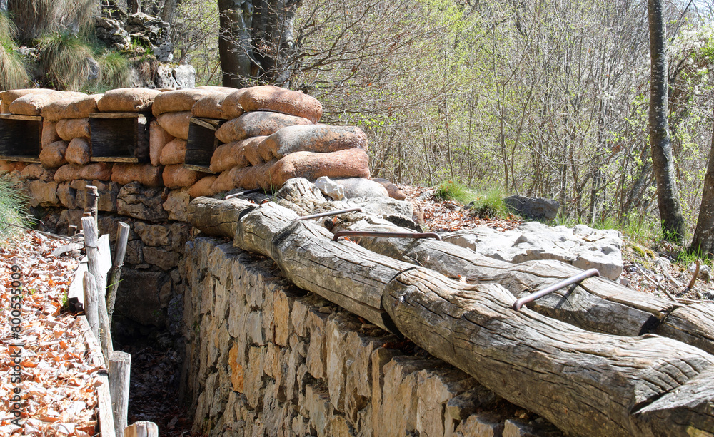inside a small trench dug in the ground and the retaining wall with ...