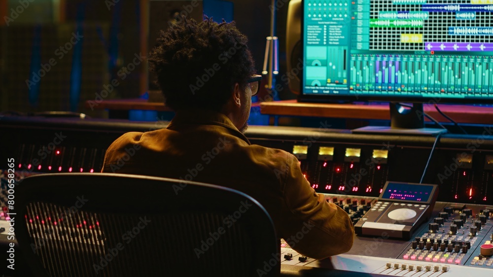 Audio expert counts down for artist singing in vocal booth, recording ...