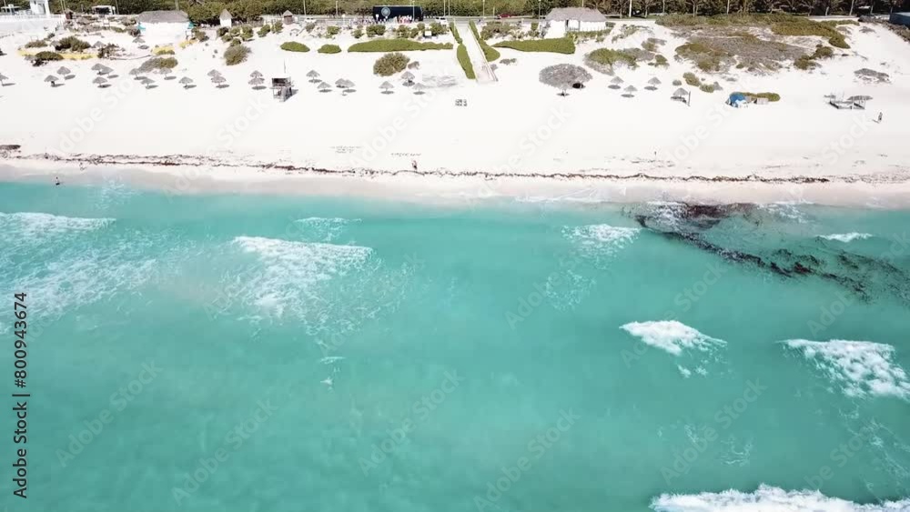 Emelard color water beach. Sand and waves. All in a tilt movement ...