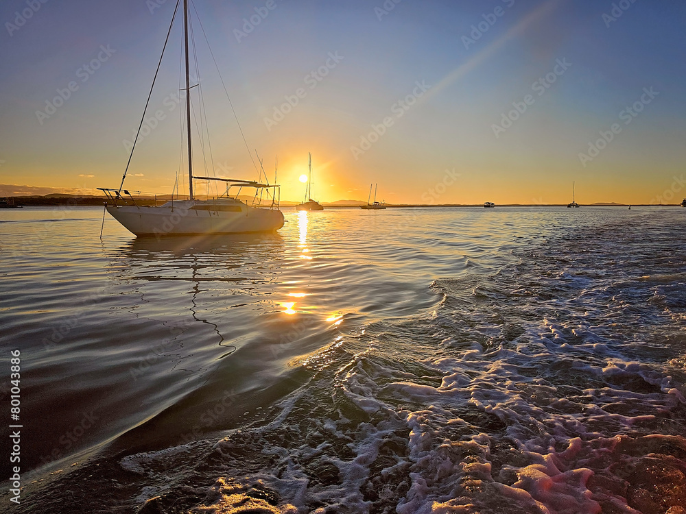 sunset with wake of boat, dynamic lens flare, boat silhouette horizon ...