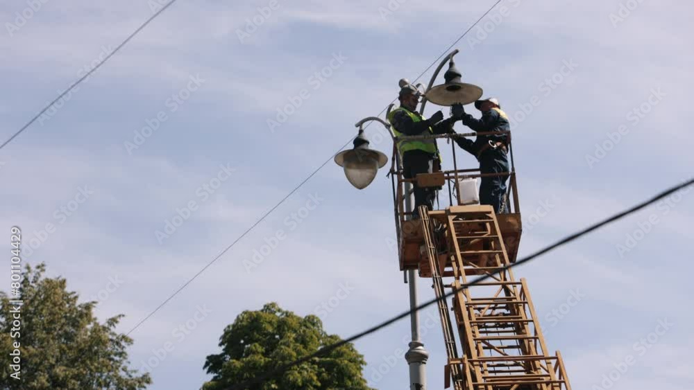 worker repair, during installation, metal pole. Street light repair ...