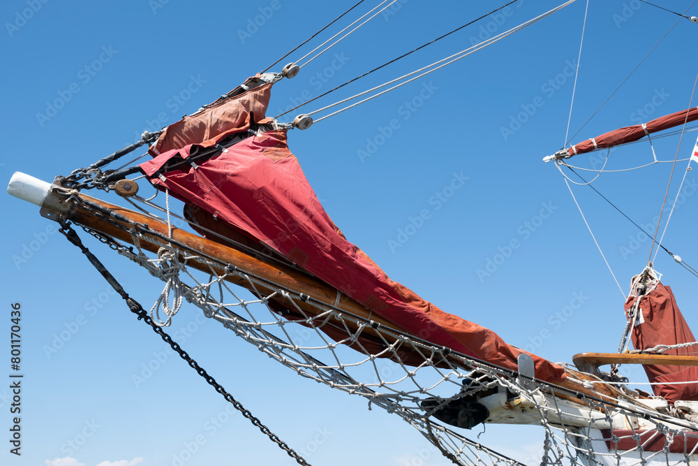 Ship's bow with jib boom and knotted jib net in front of the foremast ...