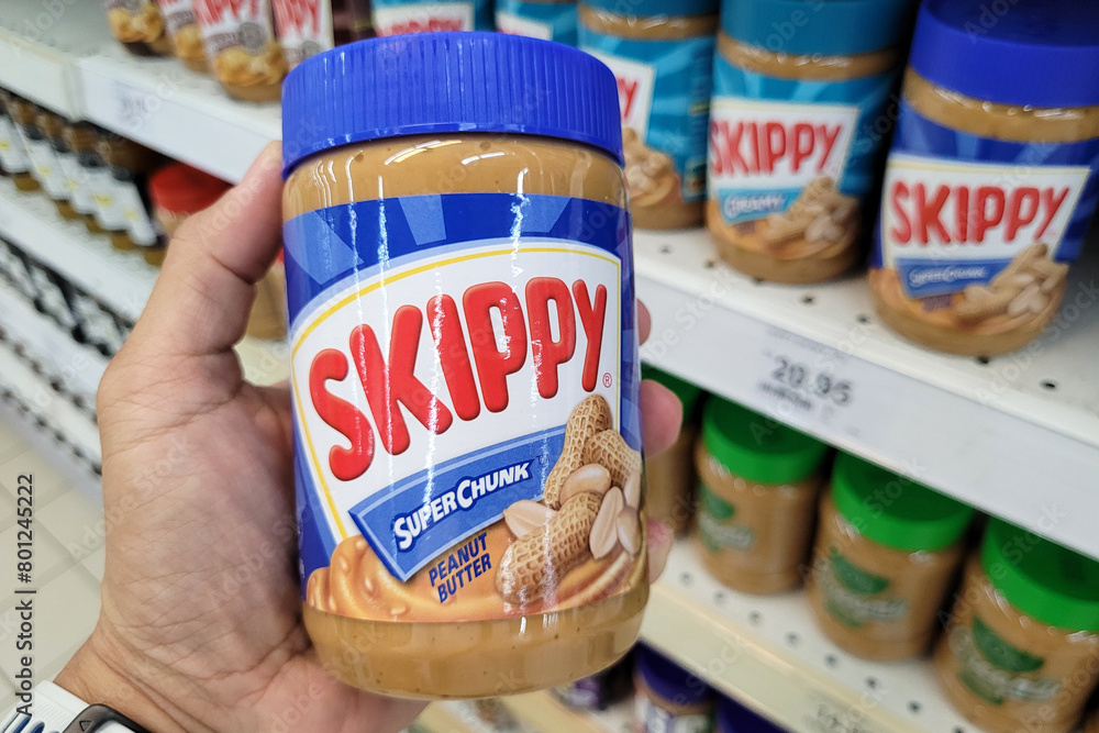 PENANG, MALAYSIA - 30 APR 2024: Close up an adult hand holding a jar of ...