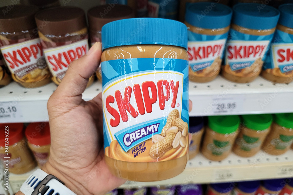 PENANG, MALAYSIA - 30 APR 2024: Close up an adult hand holding a jar of ...