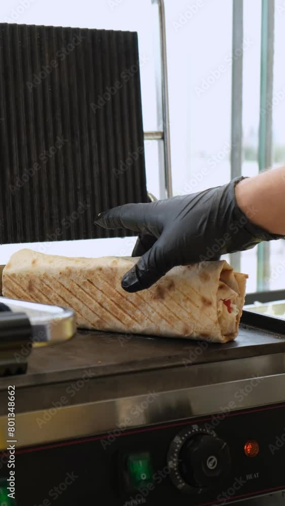 cooking shawarma, doner kebab. Delicious fat junk foods served in take ...