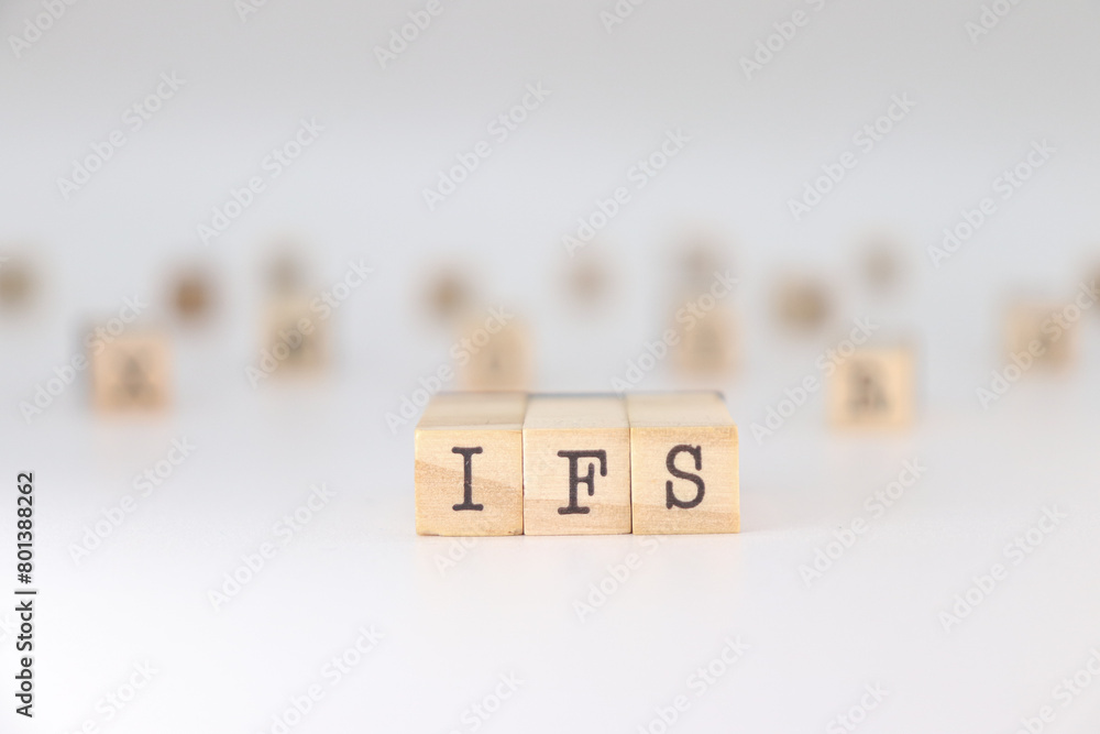 IFS acronym. Concept of Internal Family Systems written on wooden cubes ...