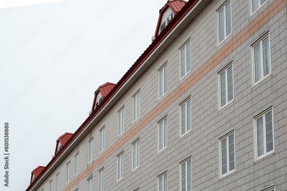 The top exterior roof section of a modern building with multiple glass ...