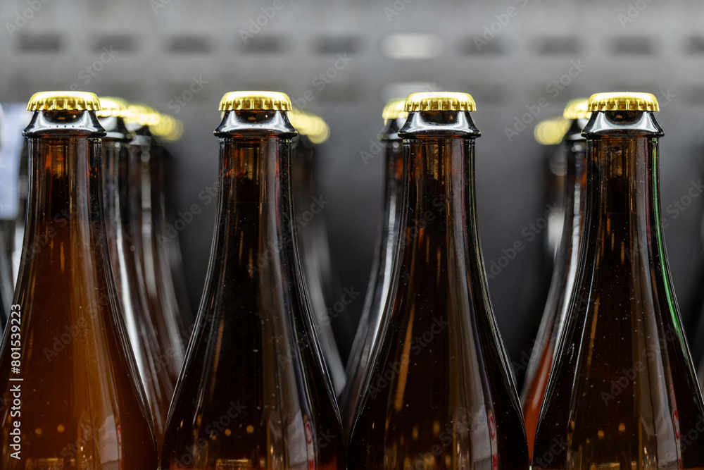 Multiple rows of long sleek neck brown beer bottles. The craft beer ...