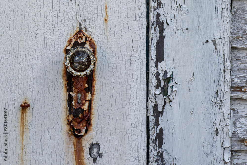 A white wooden door with a vintage decorative glass door knob. The ...