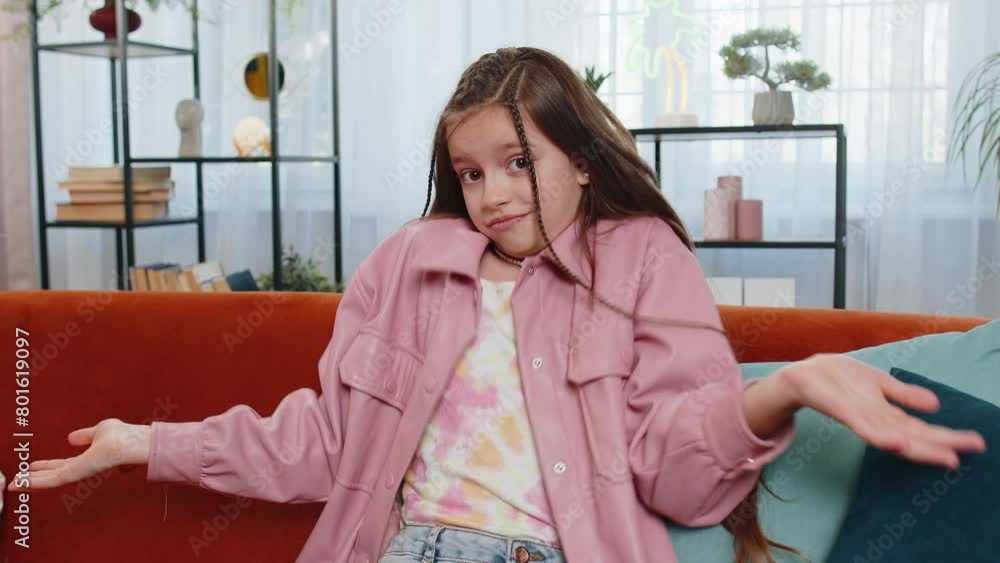 I don't know what to say. Confused young girl child feeling embarrassed ...