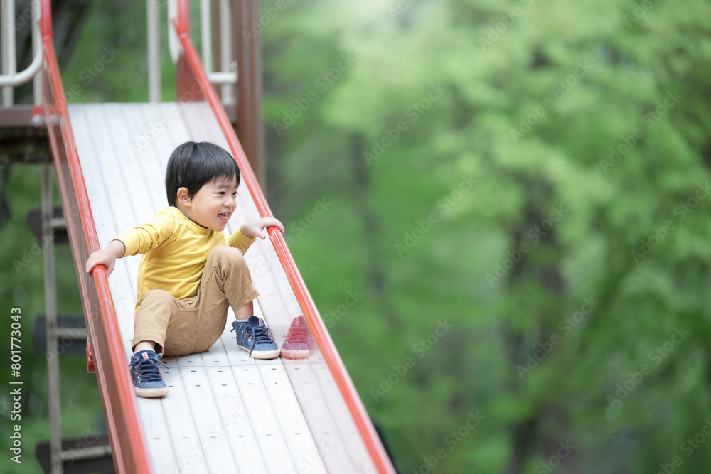 Toddler playing on a slide Images of children playing in a park and ...