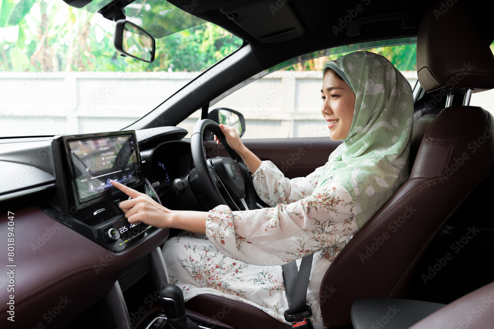 Asian muslim islamic woman driving in a car traveling using automobile ...
