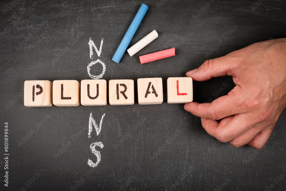 Plural nouns. Wooden block crossword puzzle and pieces of chalk on a ...