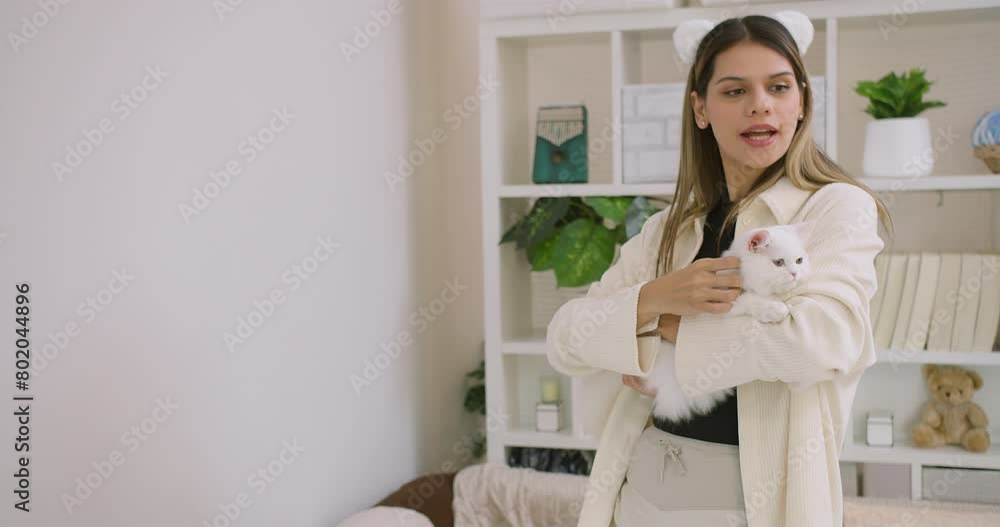 Stockvideon Cute pretty young beautiful woman is holding hugging ...