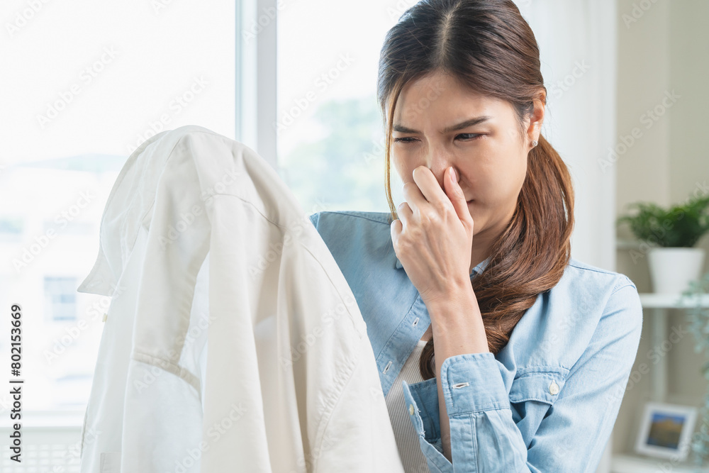 Smelly clothes laundry, housewife woman having bad smelling clothes on ...