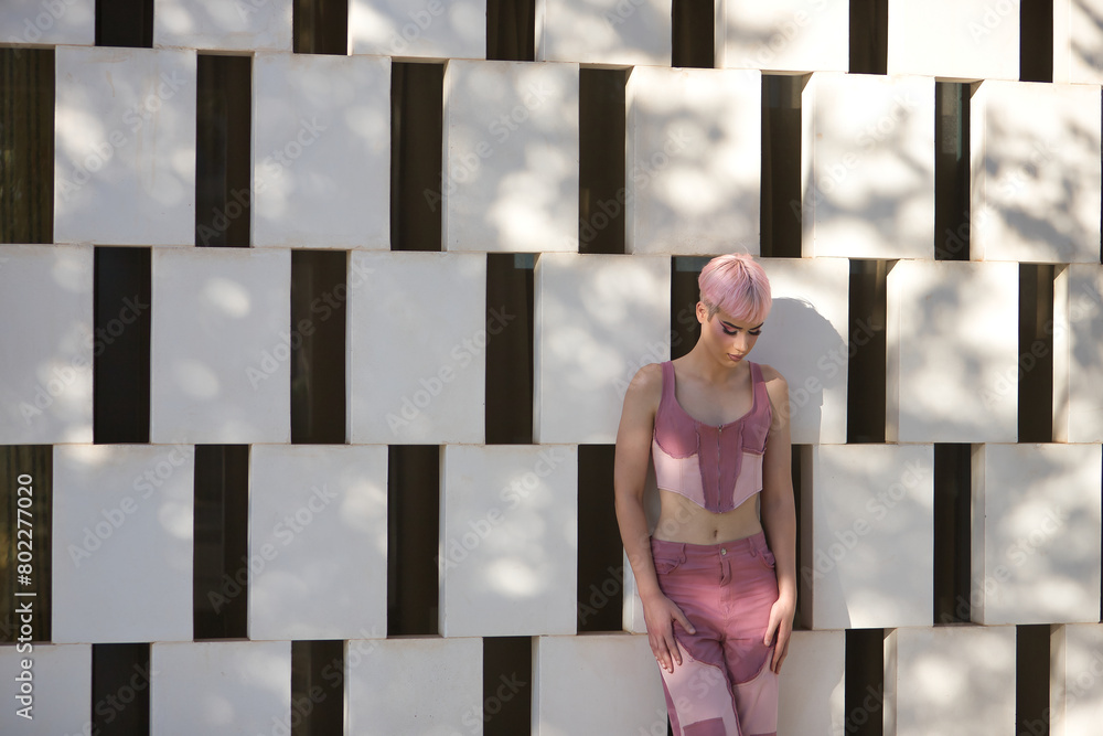 Young, attractive, gay, heavily makeup man with pink hair, top and ...