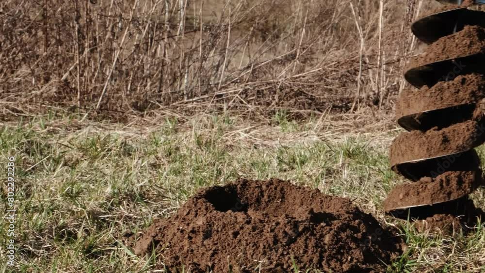 A man sticks a drill out of the ground. Drilling with rig machine ...