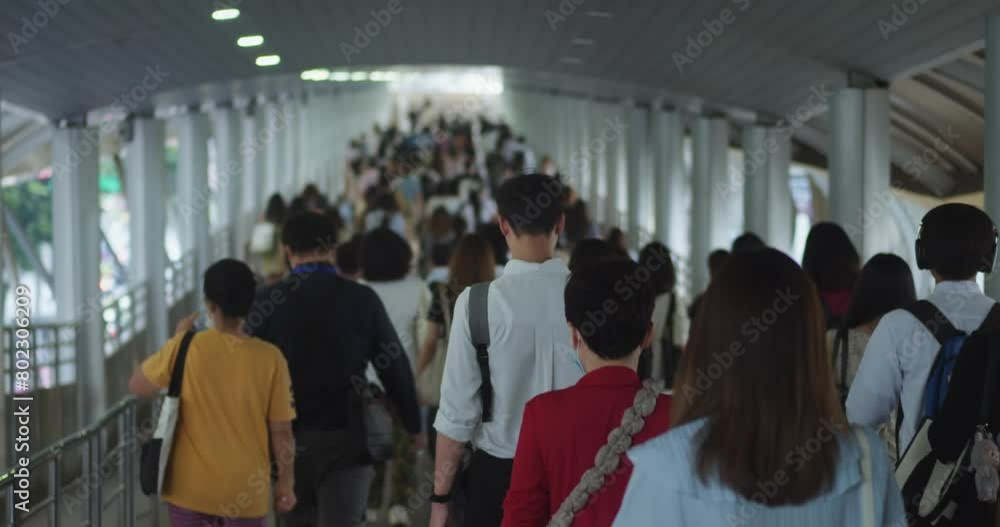 Bustling metropolis crowd of people moves through elevated passage ...
