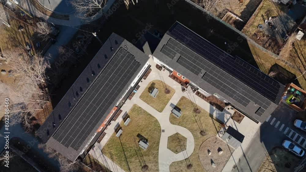 Top view of rooftops of residential buildings with solar panels on a ...