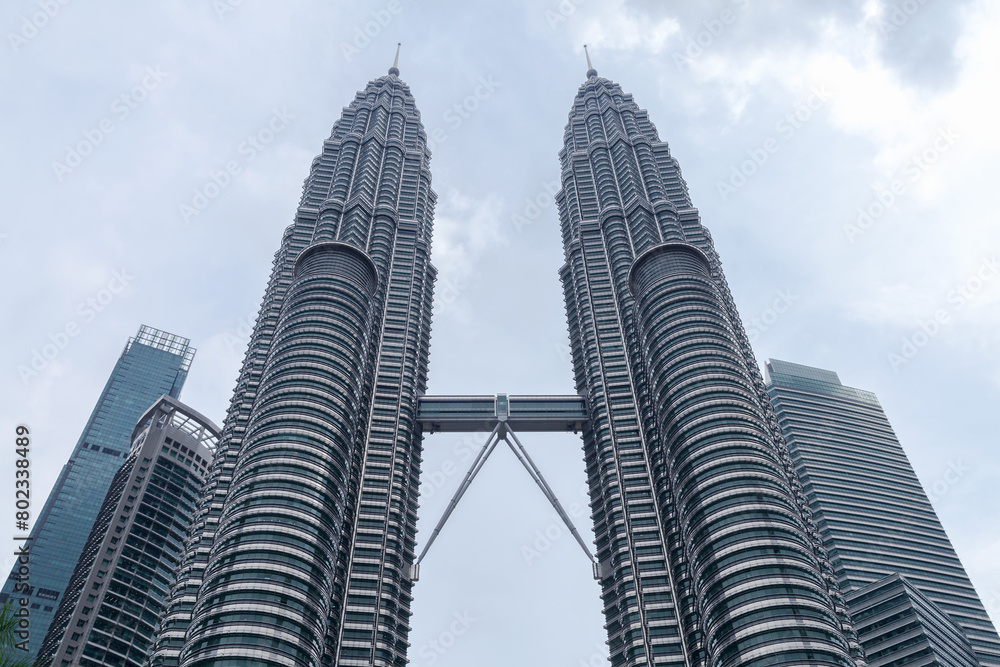 Petronas Twin Towers are under cloudy sky. Vertical photo Stock Photo ...