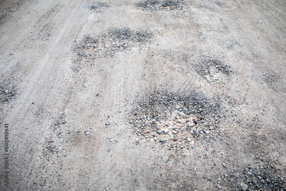 Gravel road with big potholes. Effects of weather and heavy use Stock ...