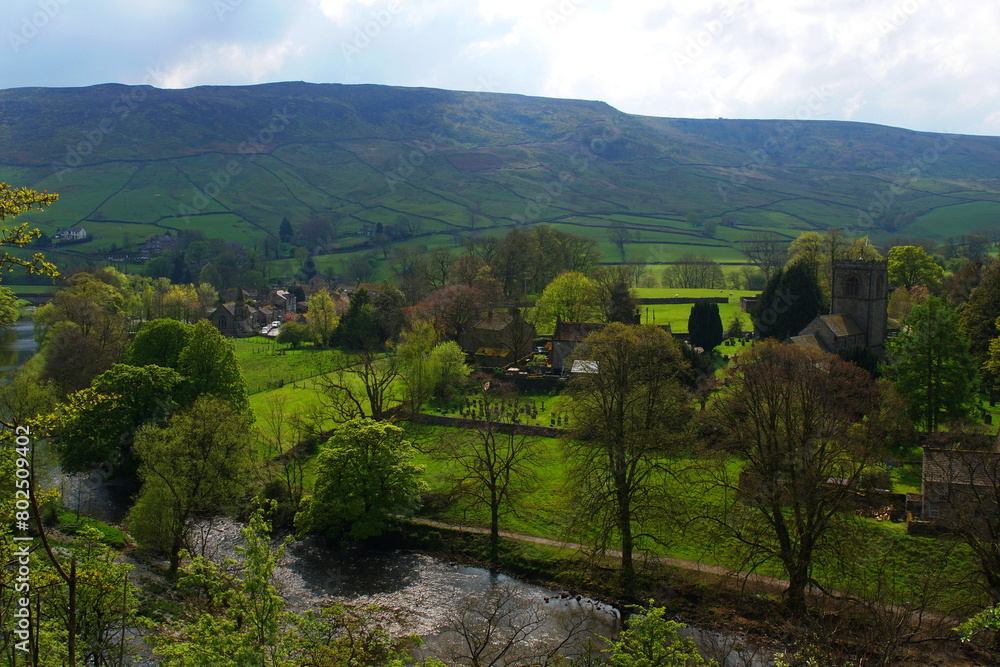 Burnsall in Wharfedale with the anchient arched bridge over the river ...